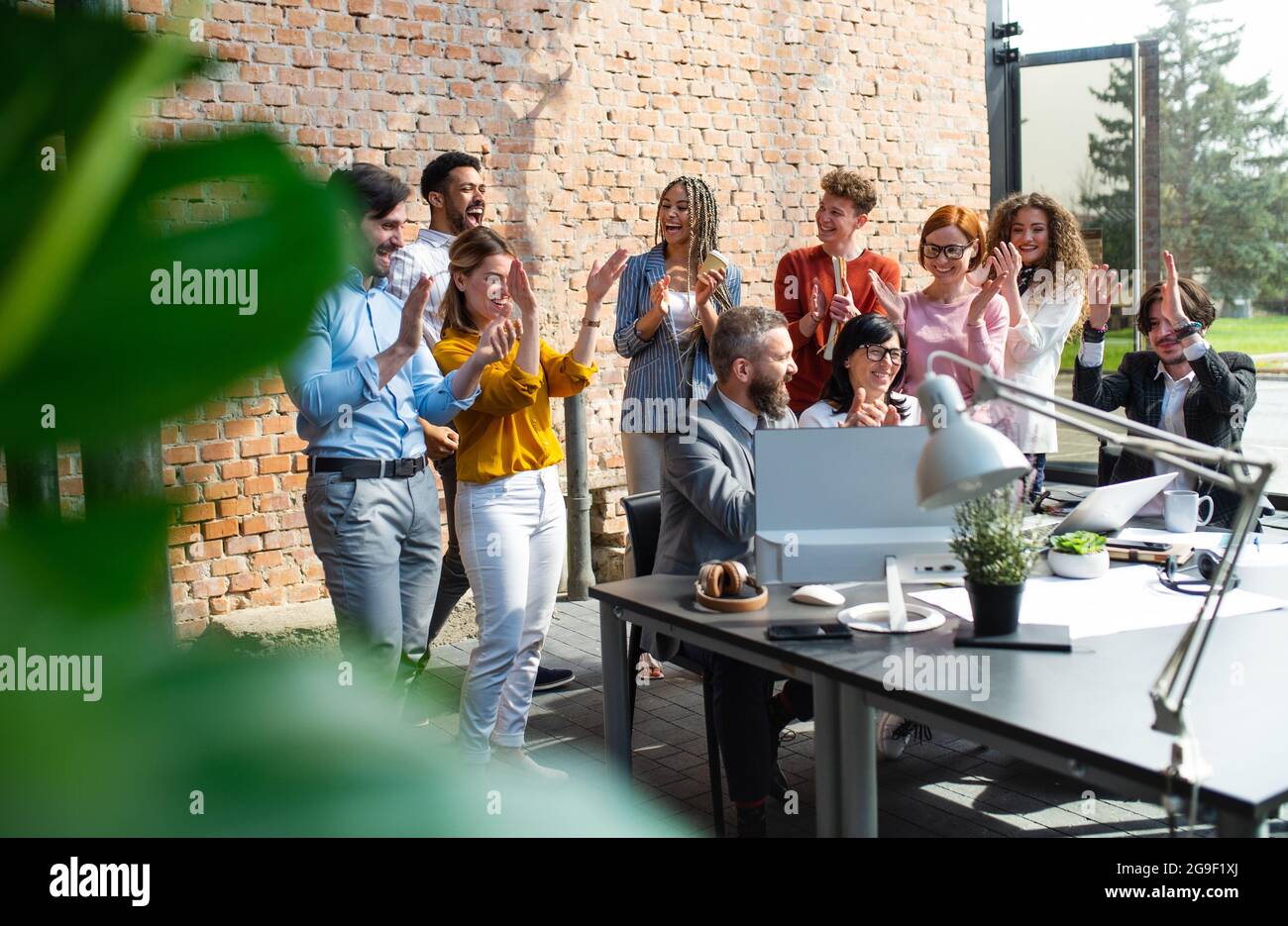 Group of excited entrepreneurs working on project indoors in office ...