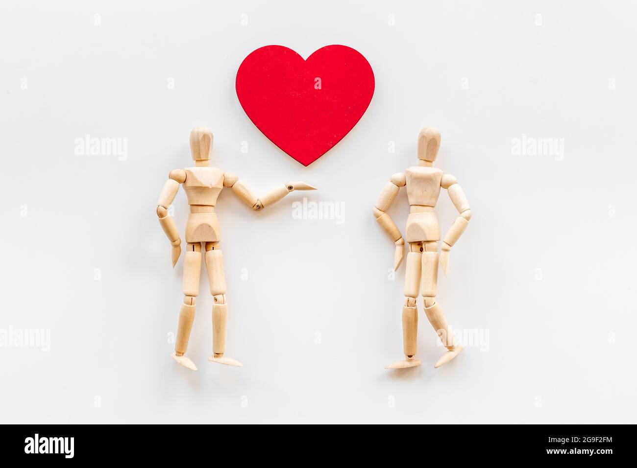 Man and woman connection. Couple of wooden mannequin figures with heart ...