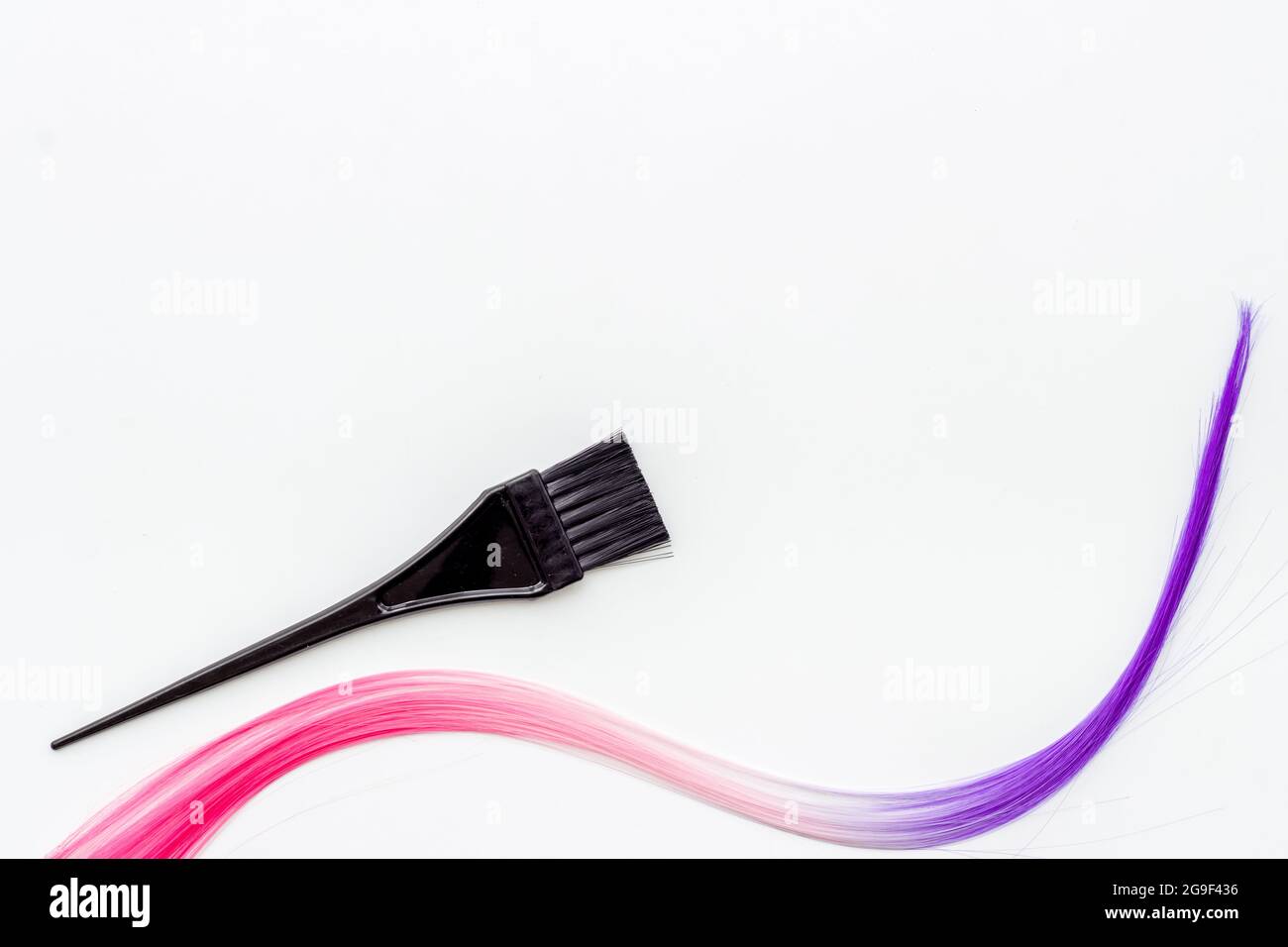 Brush and strand of coloring hair. Hair dye concept Stock Photo - Alamy