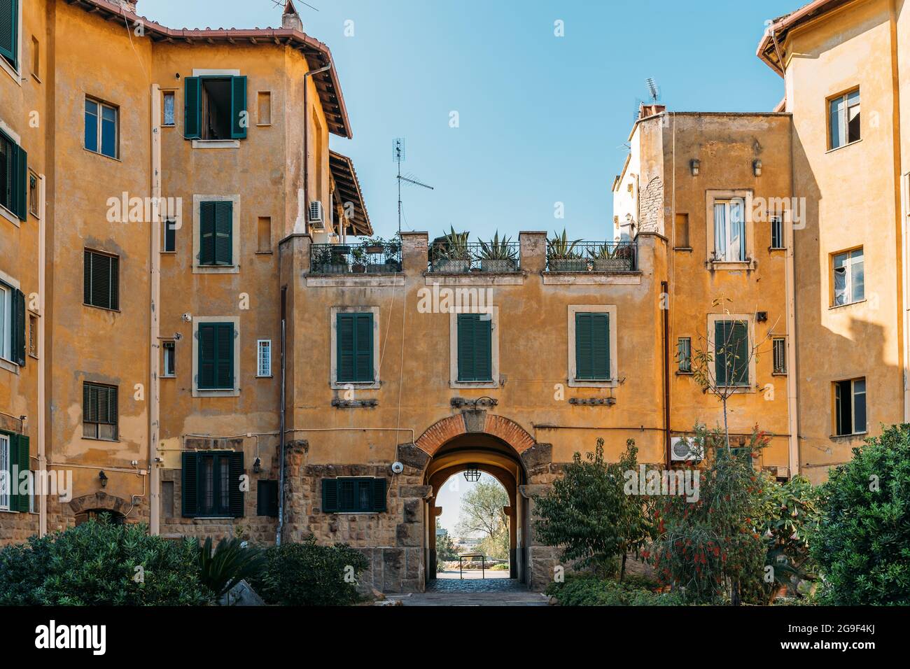 Courtyard of yellow-orange typical old Roman house in Italy Stock Photo ...