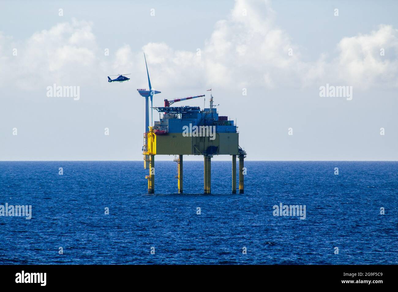 Helicopter approaching a transformer platform at an offshore wind farm ...