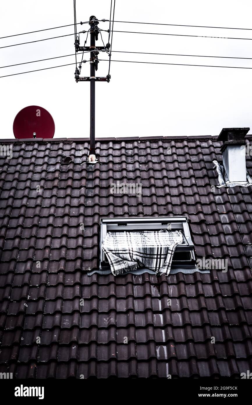House roof with a window and a power line Stock Photo - Alamy