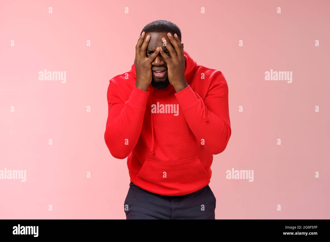 Shocked upset young african american bearded guy in red hoodie facepalm ...
