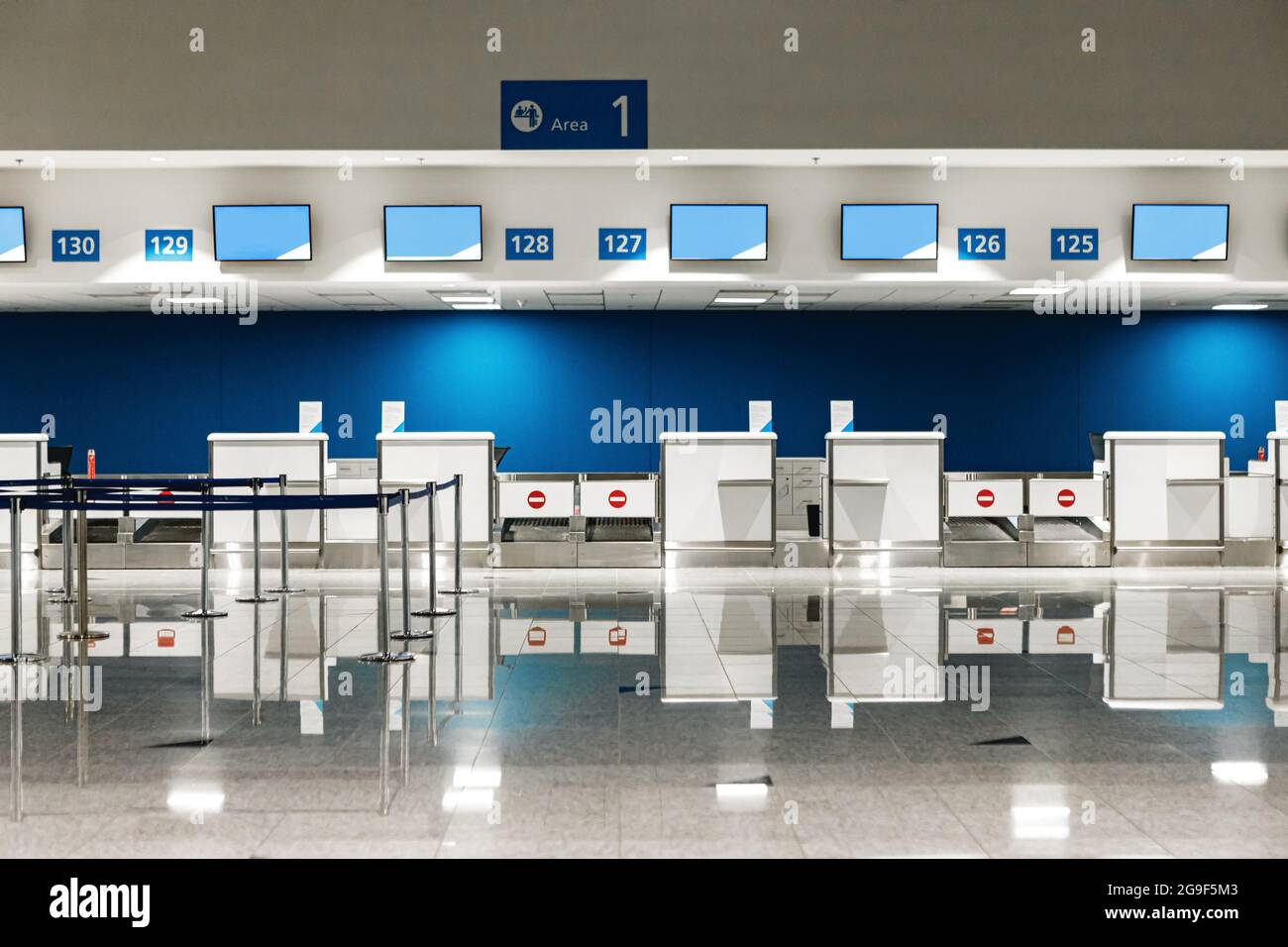 Airport check-in counters for background, no people Stock Photo - Alamy