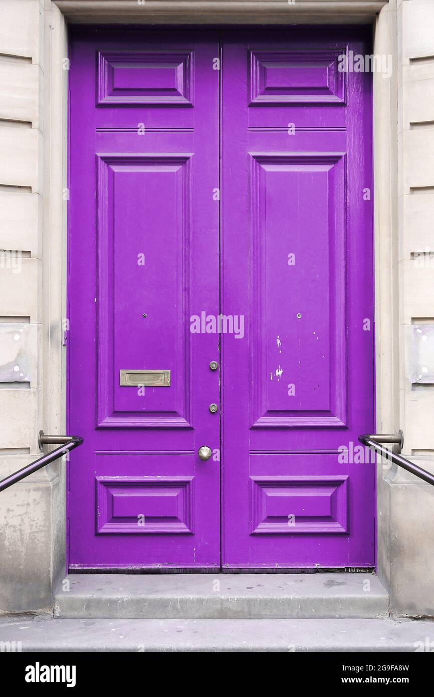 Manchester (UK). Old wooden violet painted door Stock Photo - Alamy