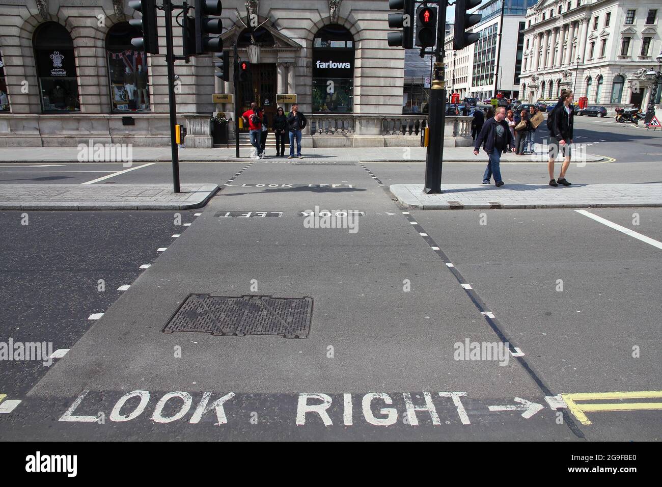LONDON, UK - MAY 13, 2012: People cross the street in London. Look ...