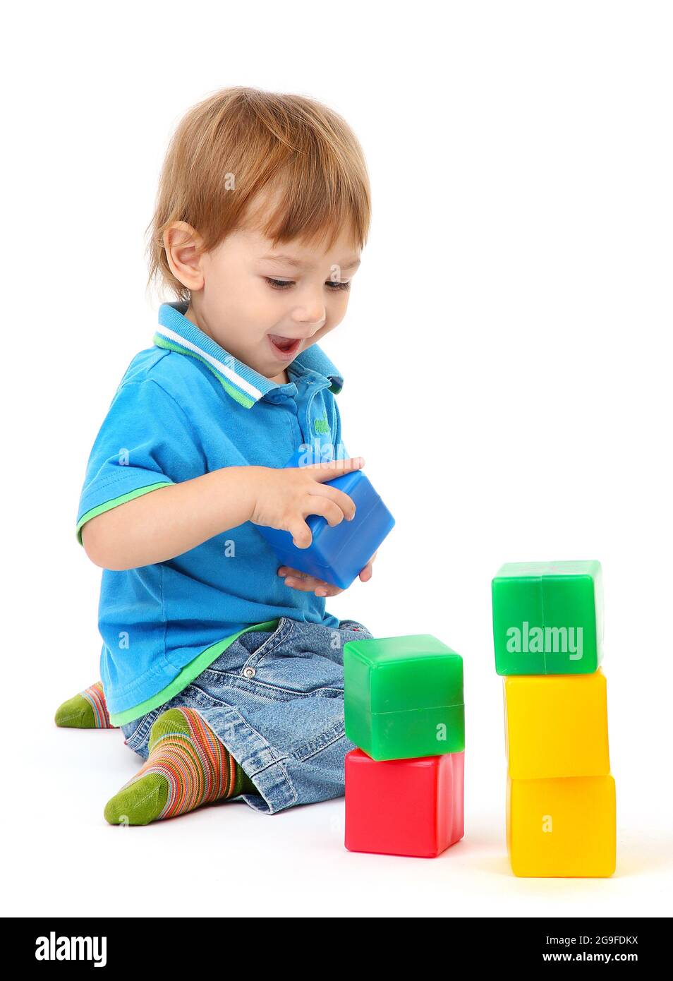 Happy children playing cubes Cut Out Stock Images & Pictures - Alamy