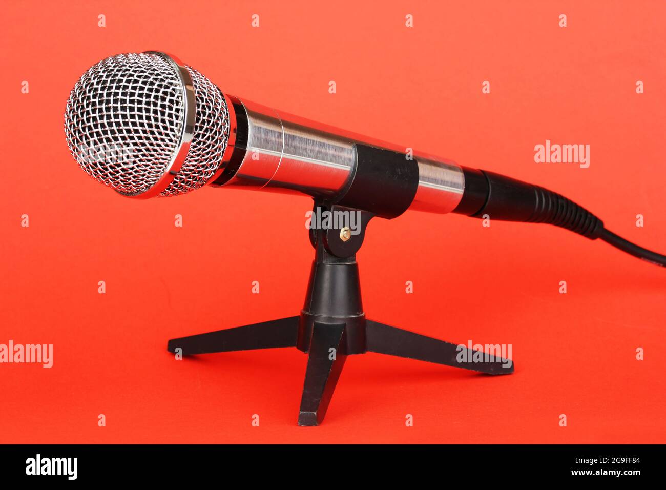 Microphone on stand on red background Stock Photo - Alamy