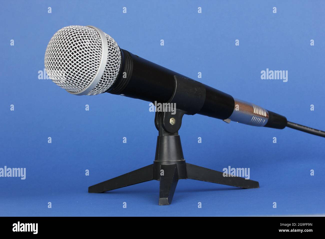 Microphone on blue background Stock Photo - Alamy