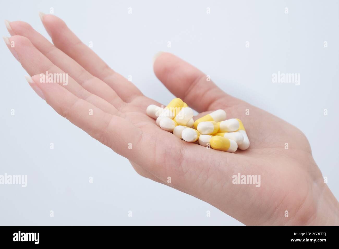 The capsules with the medicine are placed in the palm of the patient's ...