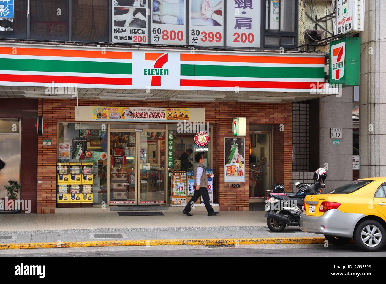TAIPEI, TAIWAN - DECEMBER 5, 2018: People walk by 7-Eleven convenience ...