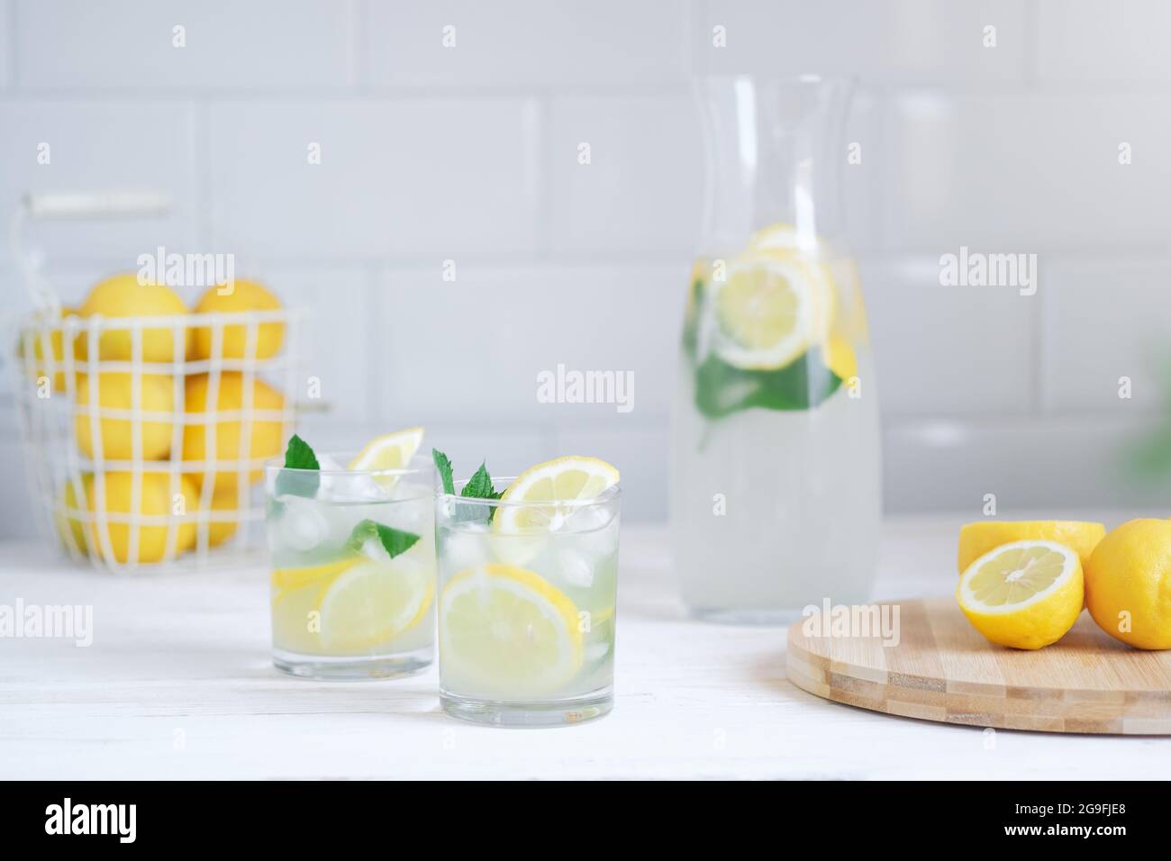 Fresh lemon lemonade with mint in bottle on kitchen table with ...