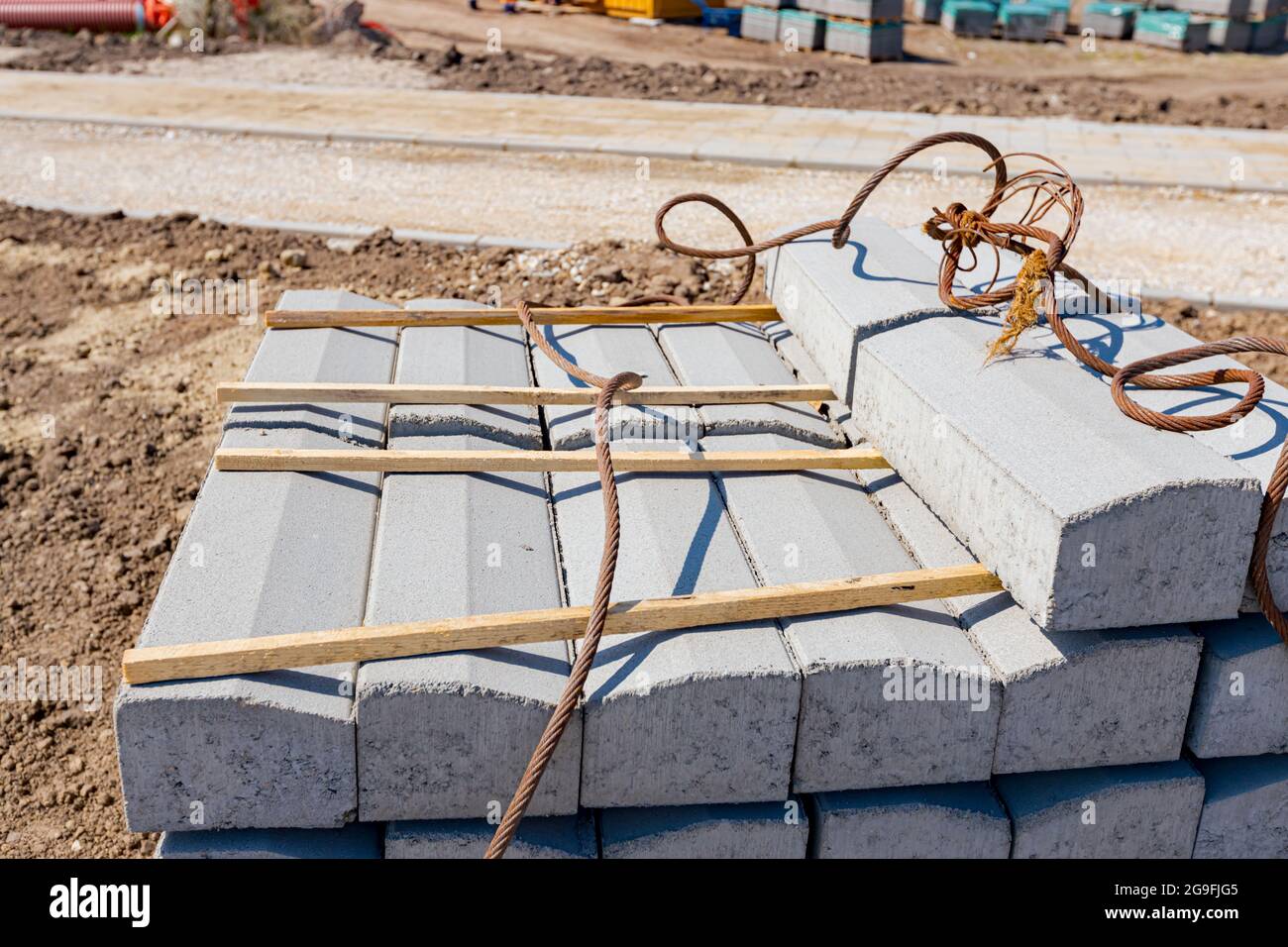 Stack of packed border stones for asphalt road on wooden pallet at ...