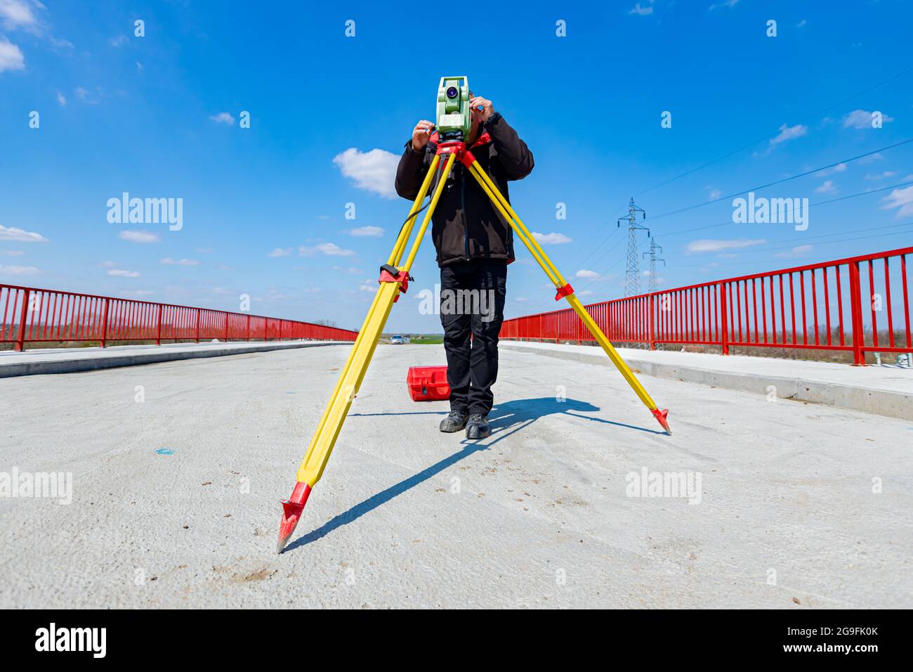 Surveyor engineer is measuring bridge under construction, site ...