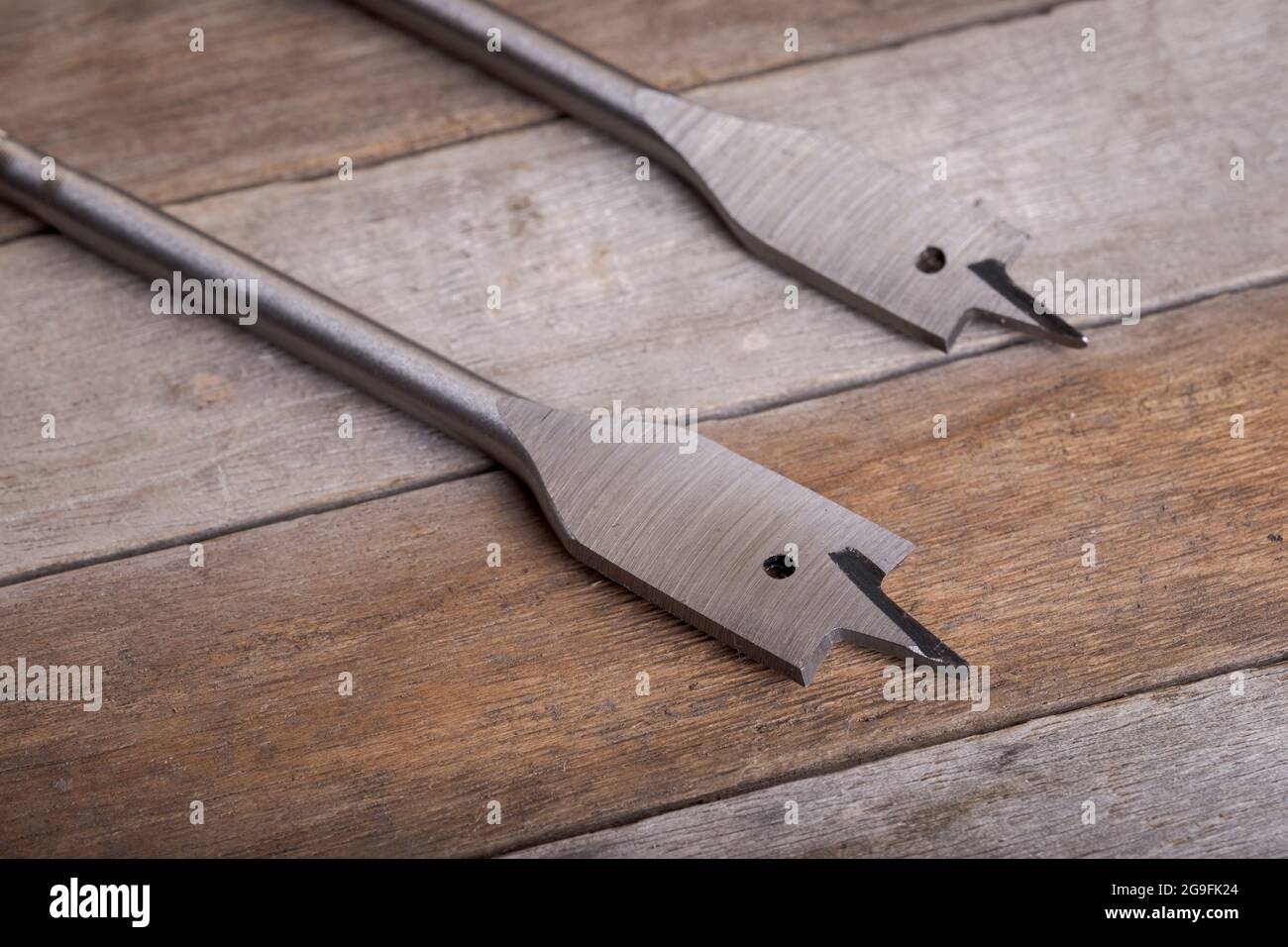 Feather wood drill bit on wooden background. Drill bit for wood on ...
