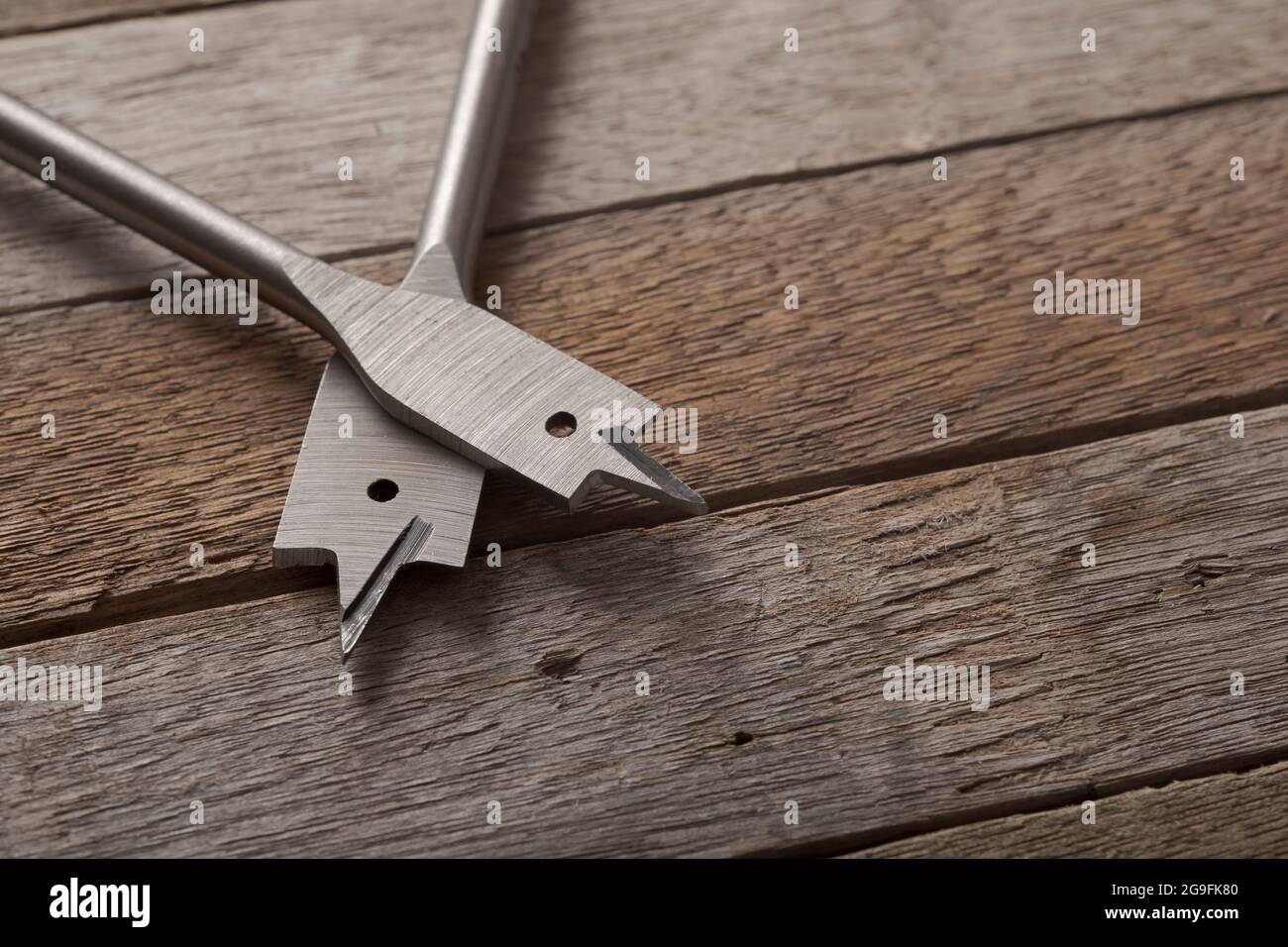 Feather wood drill bit on wooden background. Drill bit for wood on ...