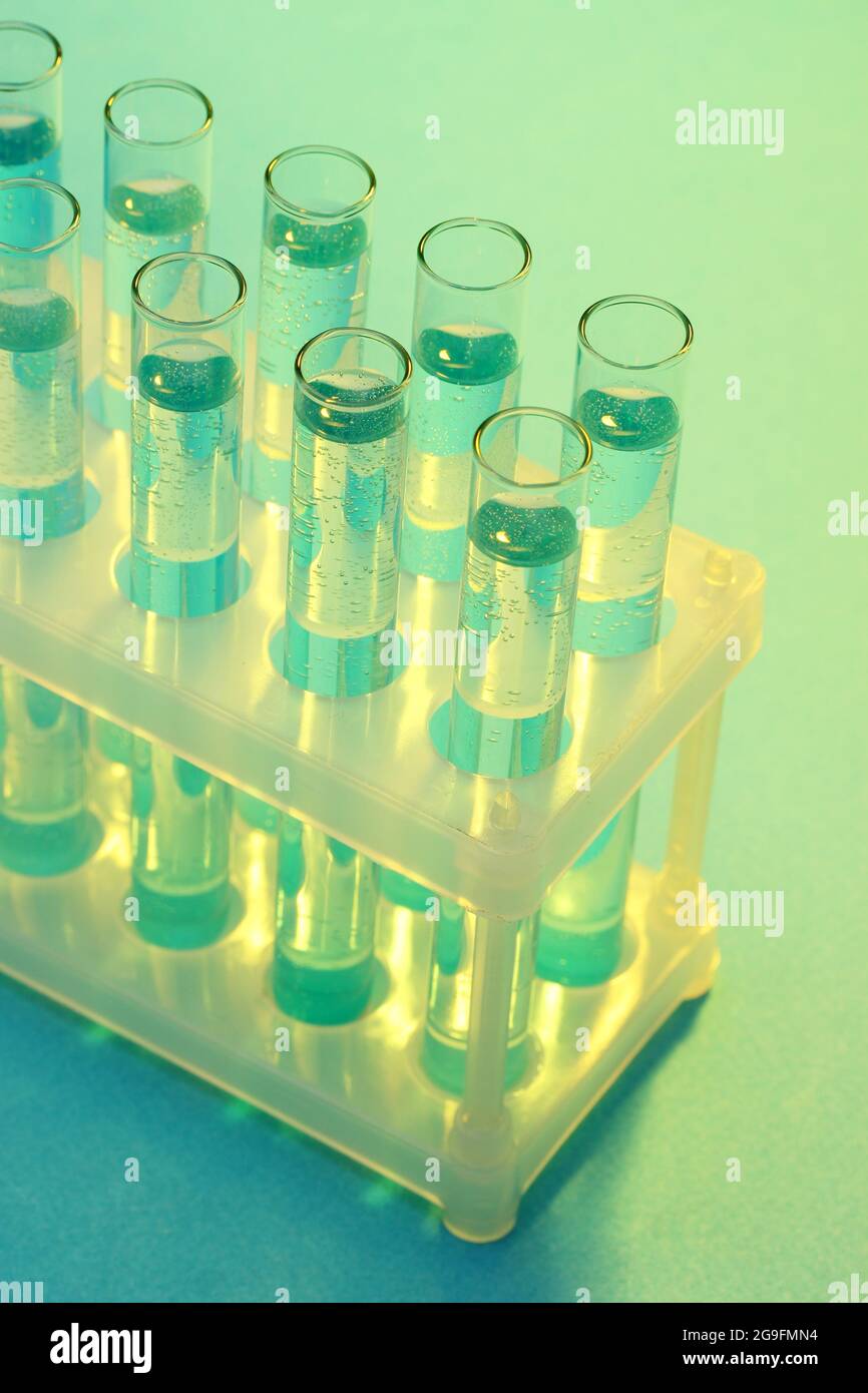 test-tubes with liquid on blue background Stock Photo - Alamy
