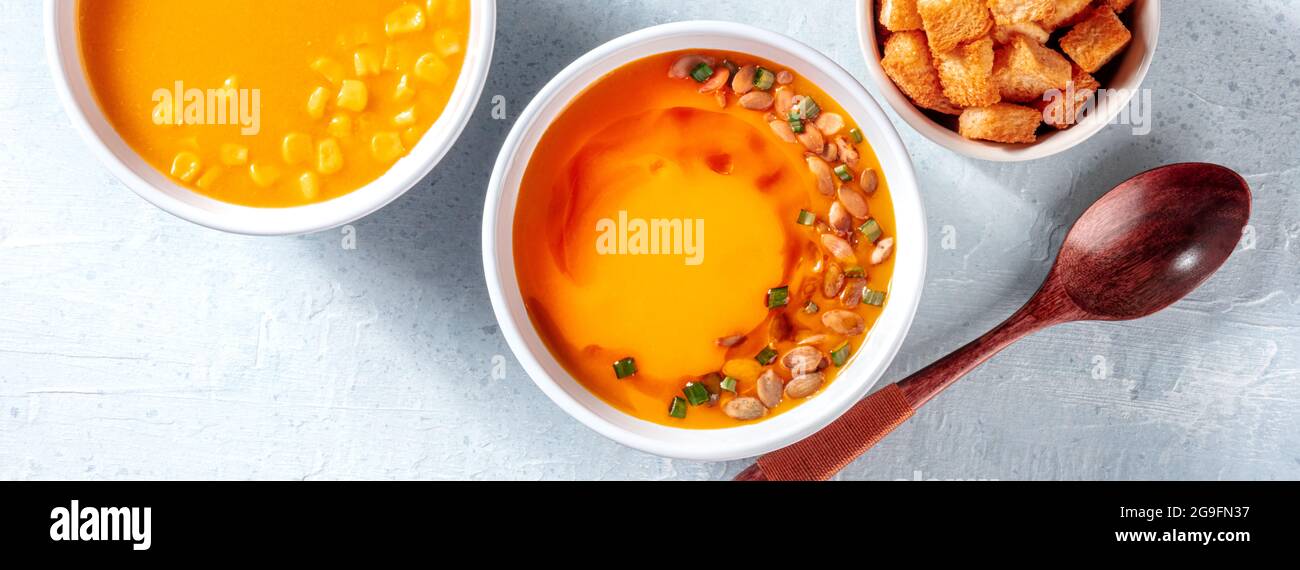 Vegan soup panorama, overhead flat lay shot. Pumpkin and corn cream ...