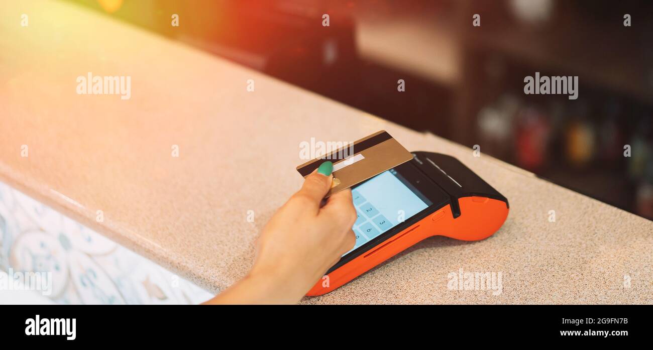 Contactless payment from card via pos terminal Stock Photo - Alamy