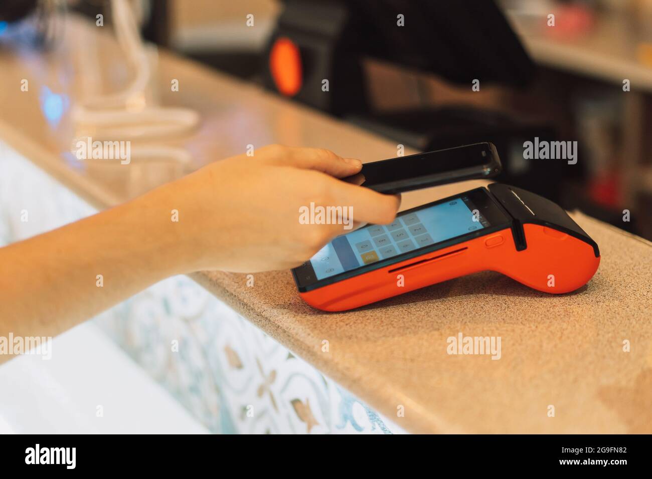 Contactless payment from the phone through the pos terminal Stock Photo ...