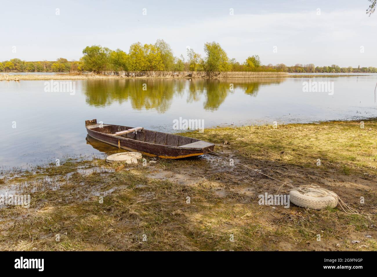 Old wooden row boat anchored on the shore Stock Photo - Alamy