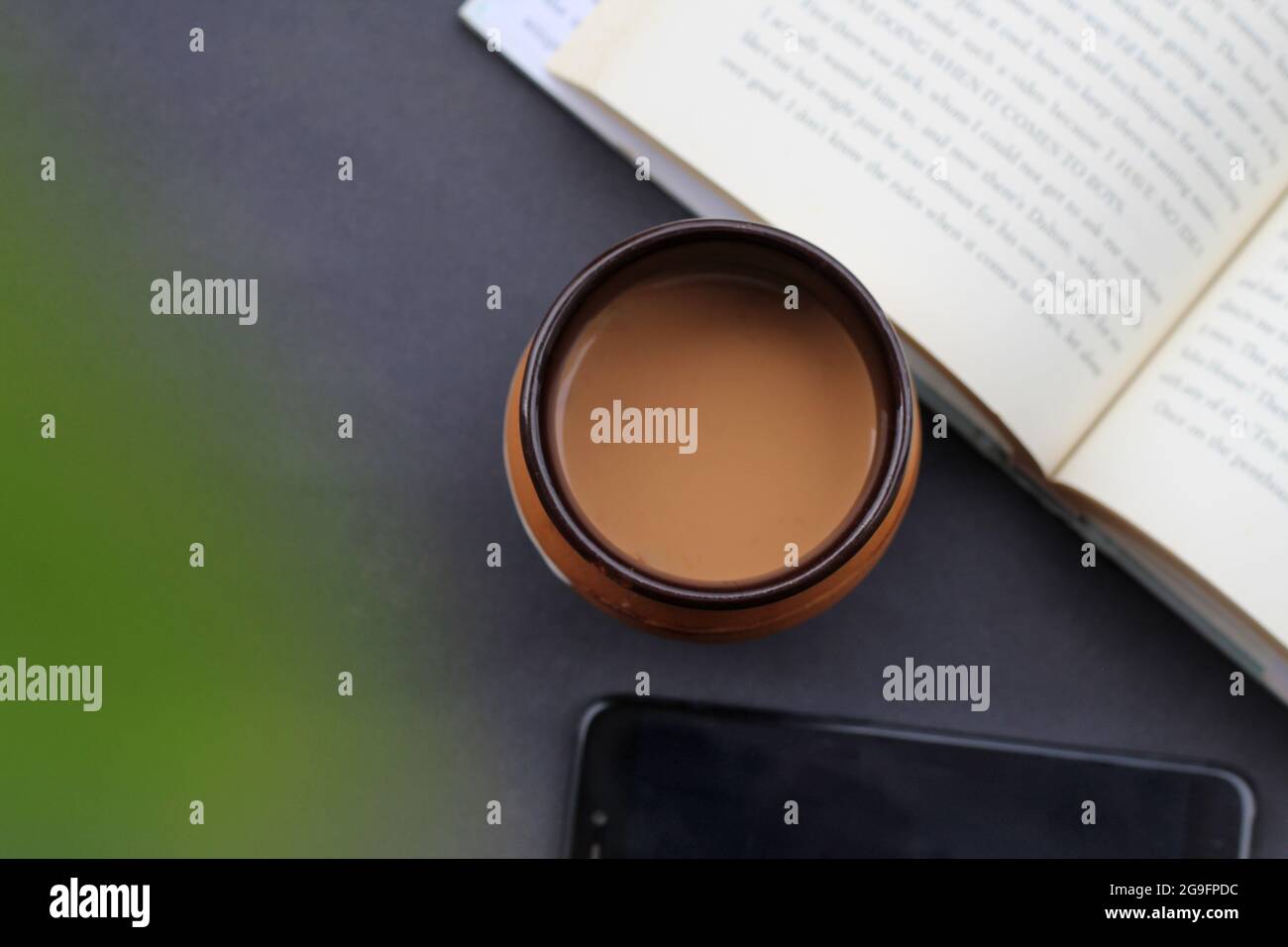 Top view of tea or chai with book and phone. Tea time, India Stock ...