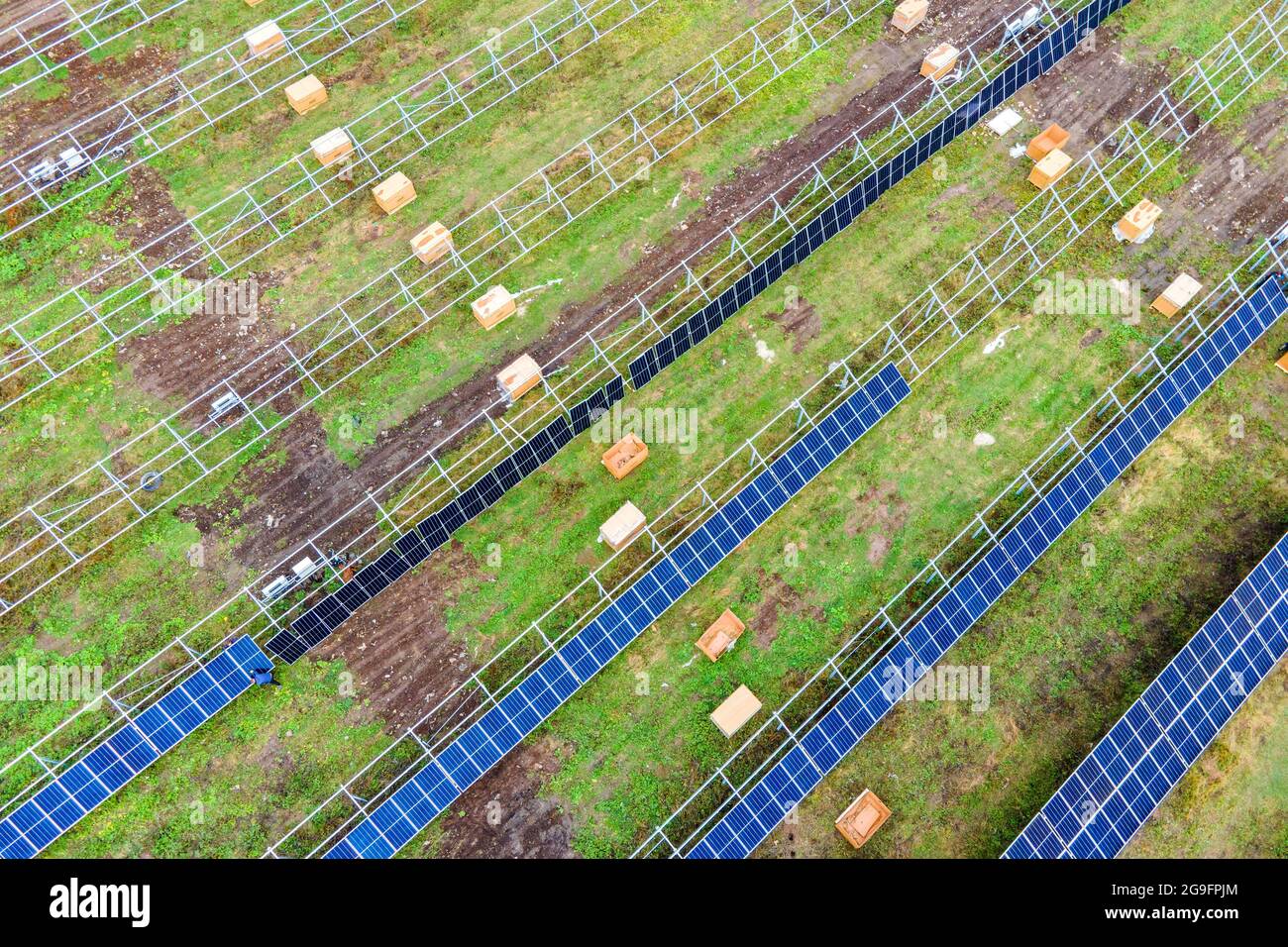 Aerial view of solar power plant under construction on green field ...