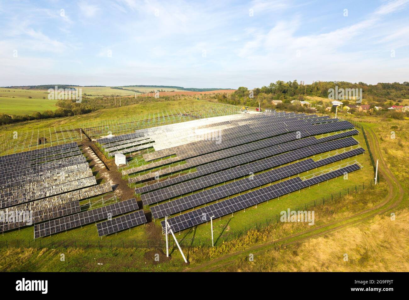Aerial view of solar power plant under construction on green field ...
