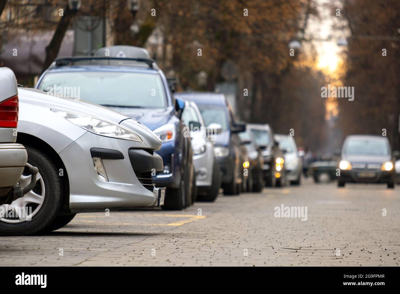Cars parked in a row on a city street side Stock Photo - Alamy
