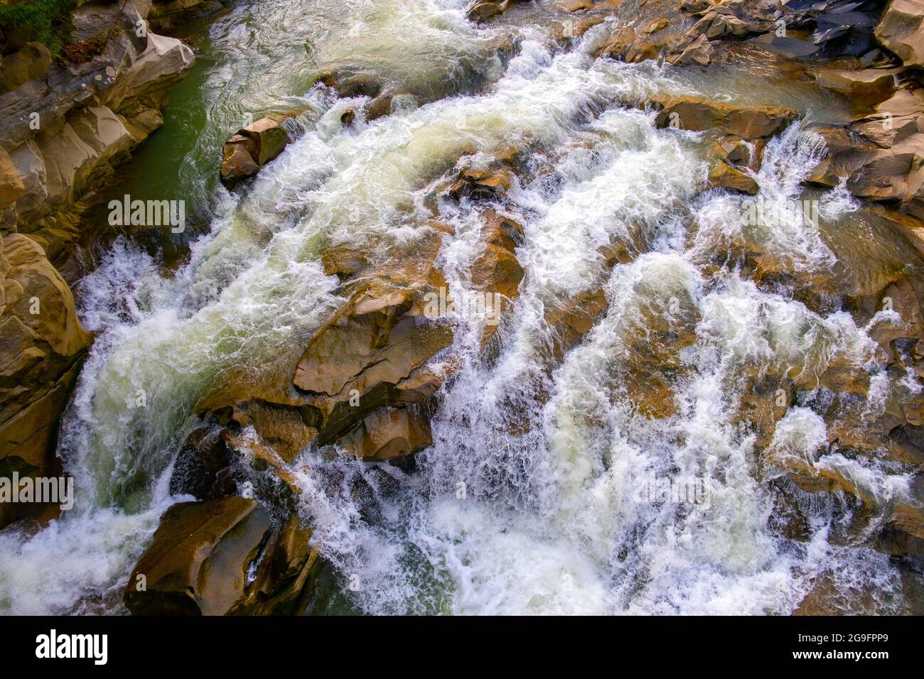 Aerial view of river waterfall with clear turquoise water falling down ...