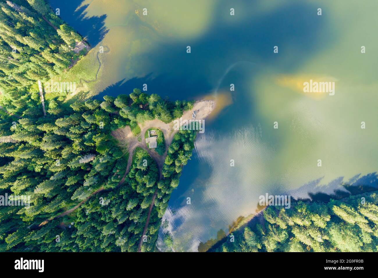 Top down aerial view of big lake with clear blue water between high ...