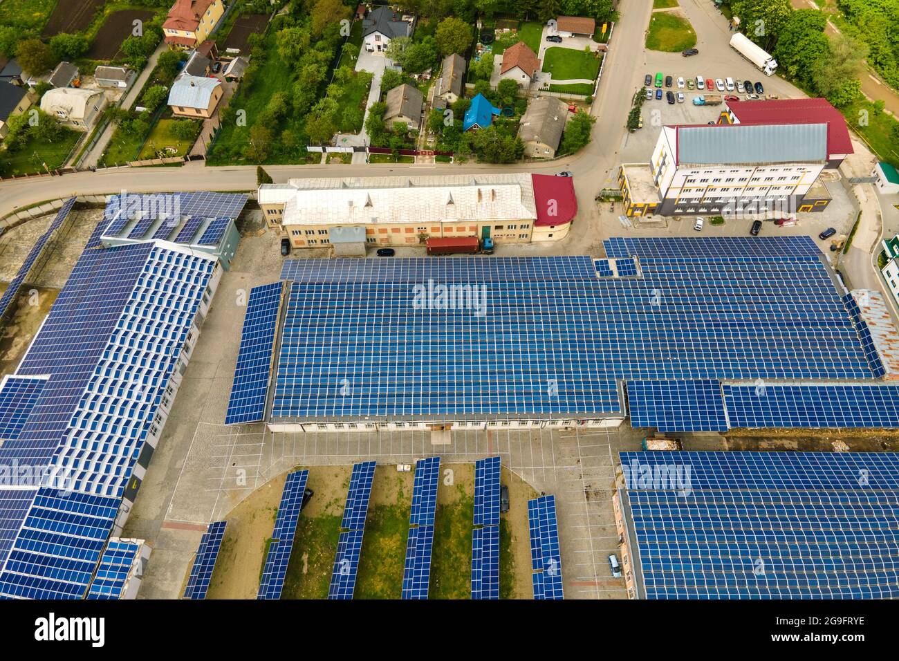 Aerial view of blue photovoltaic solar panels mounted on industrial ...