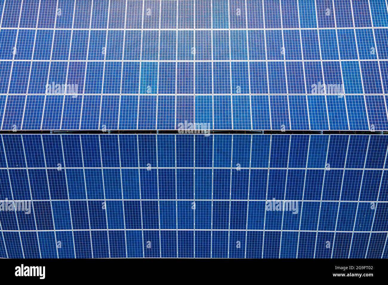 Aerial view building roof with rows of solar photovoltaic panels for ...