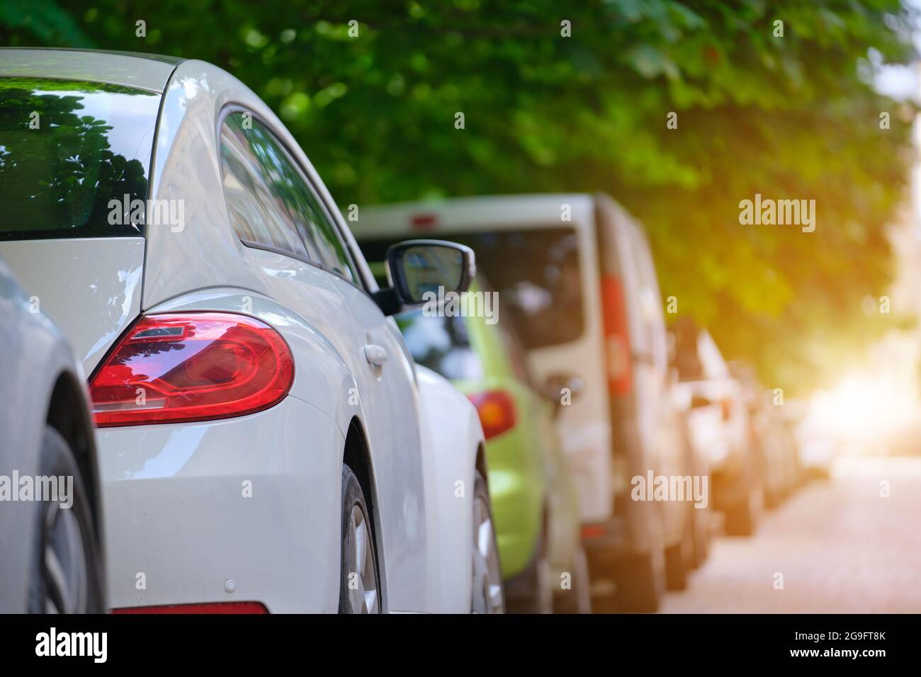 City traffic with cars parked in line on street side Stock Photo - Alamy