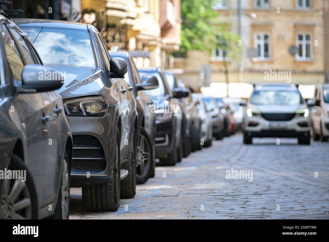 City traffic with cars parked in line on street side Stock Photo - Alamy