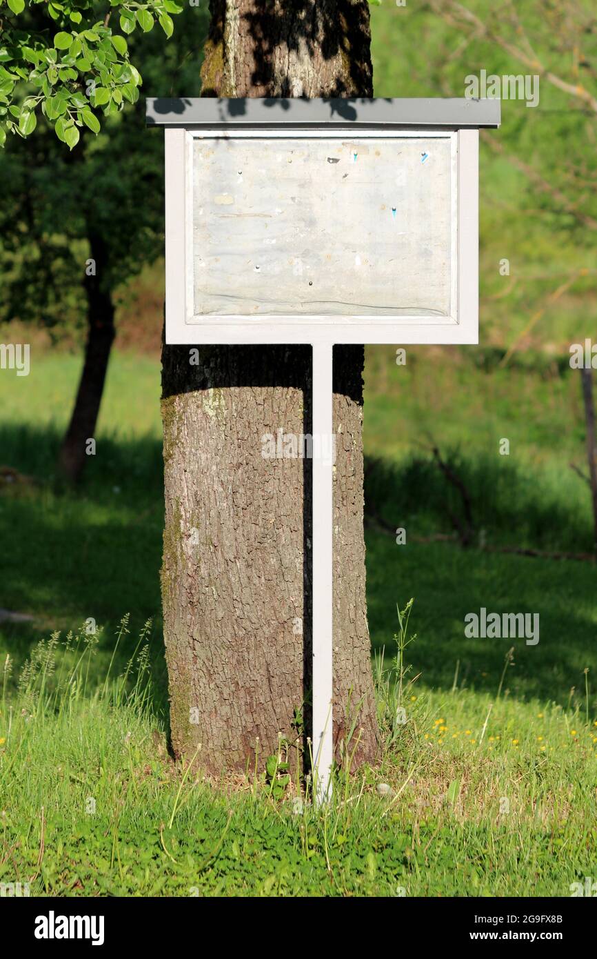 Light grey metal notice board with freshly painted frame mounted on ...