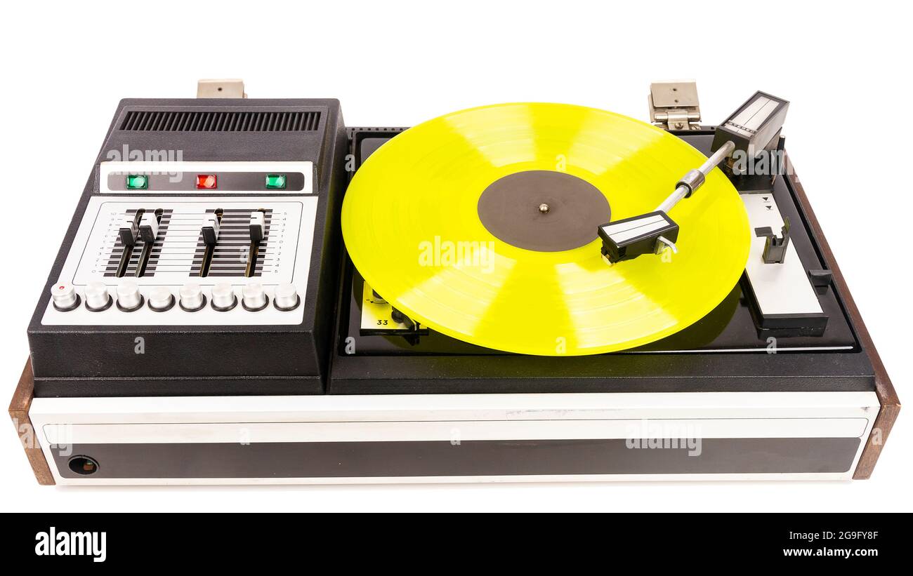 Vintage turntable record player with yellow vinyl isolated on white ...