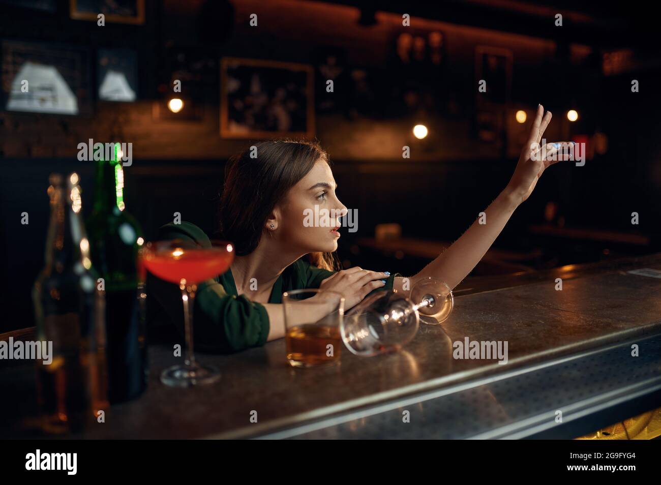 Depressed woman drinks alcohol at counter in bar Stock Photo - Alamy