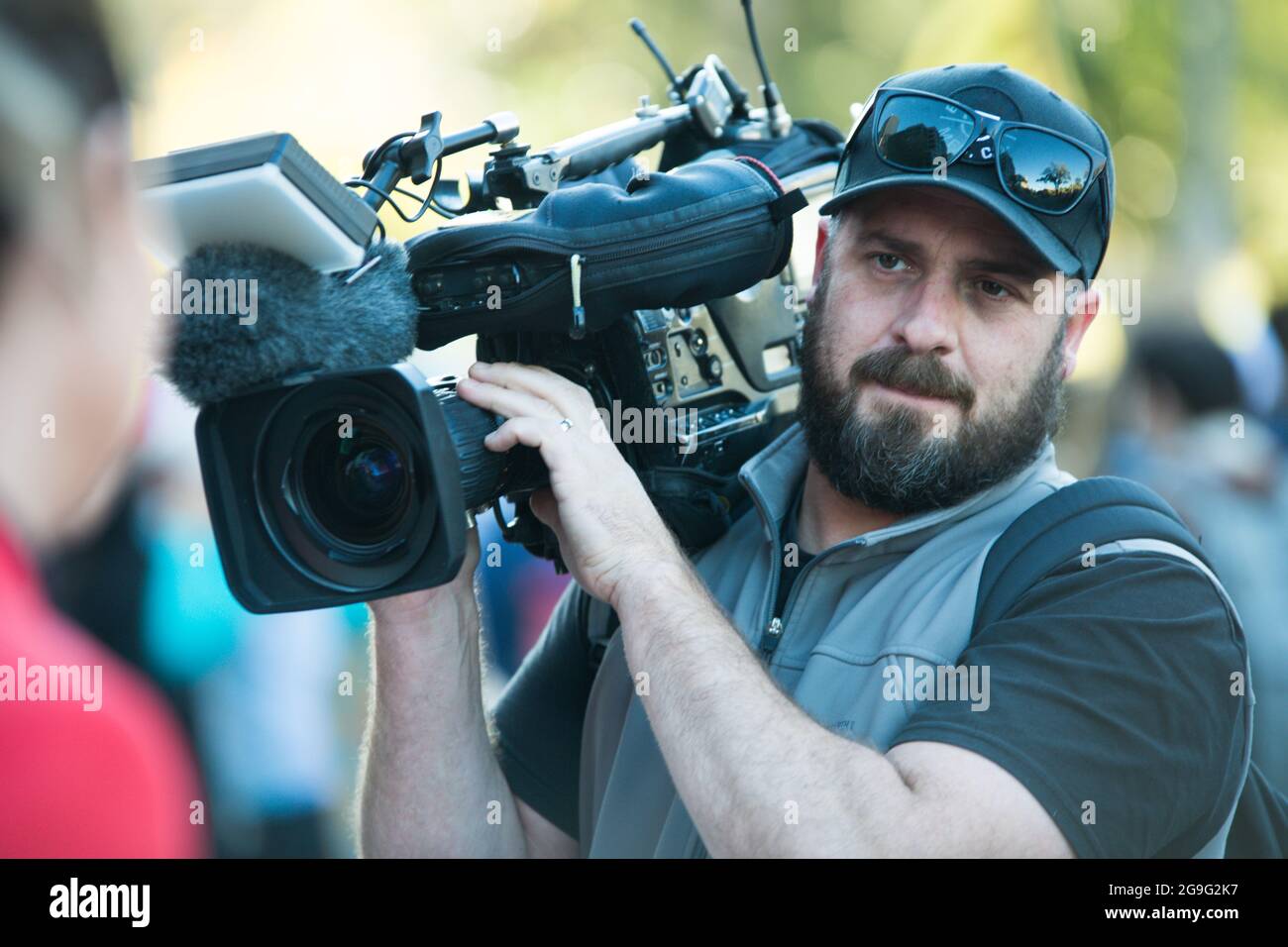 Shallow focus of an Australian news cameraman filming the climate ...