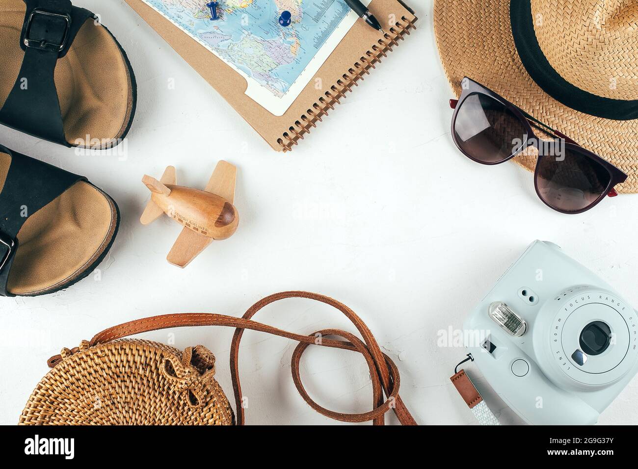Travel flat lay. Handbag, straw hat, sunglasses, sandals, camera ...