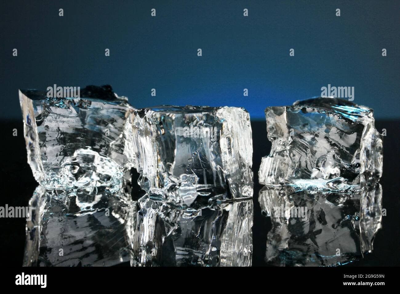 Ice cubes on dark blue background Stock Photo - Alamy