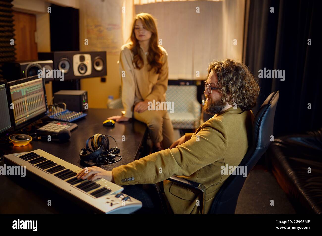 Male producer and female singer, recording studio Stock Photo - Alamy