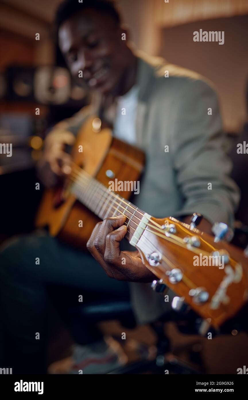 Male performer with guitar, recording studio Stock Photo - Alamy
