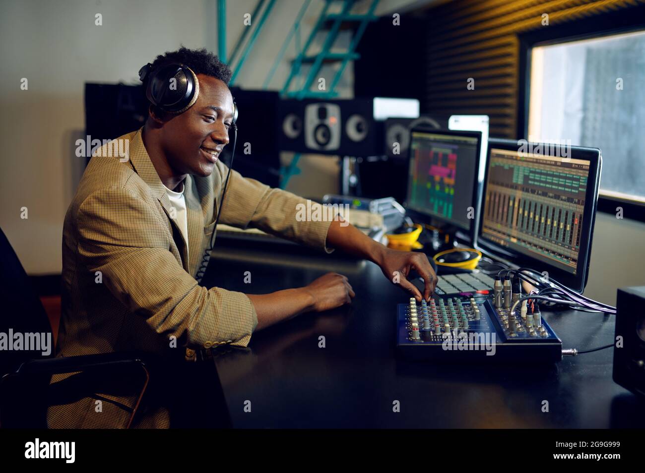 Male dj working on a new hit, recording studio Stock Photo - Alamy