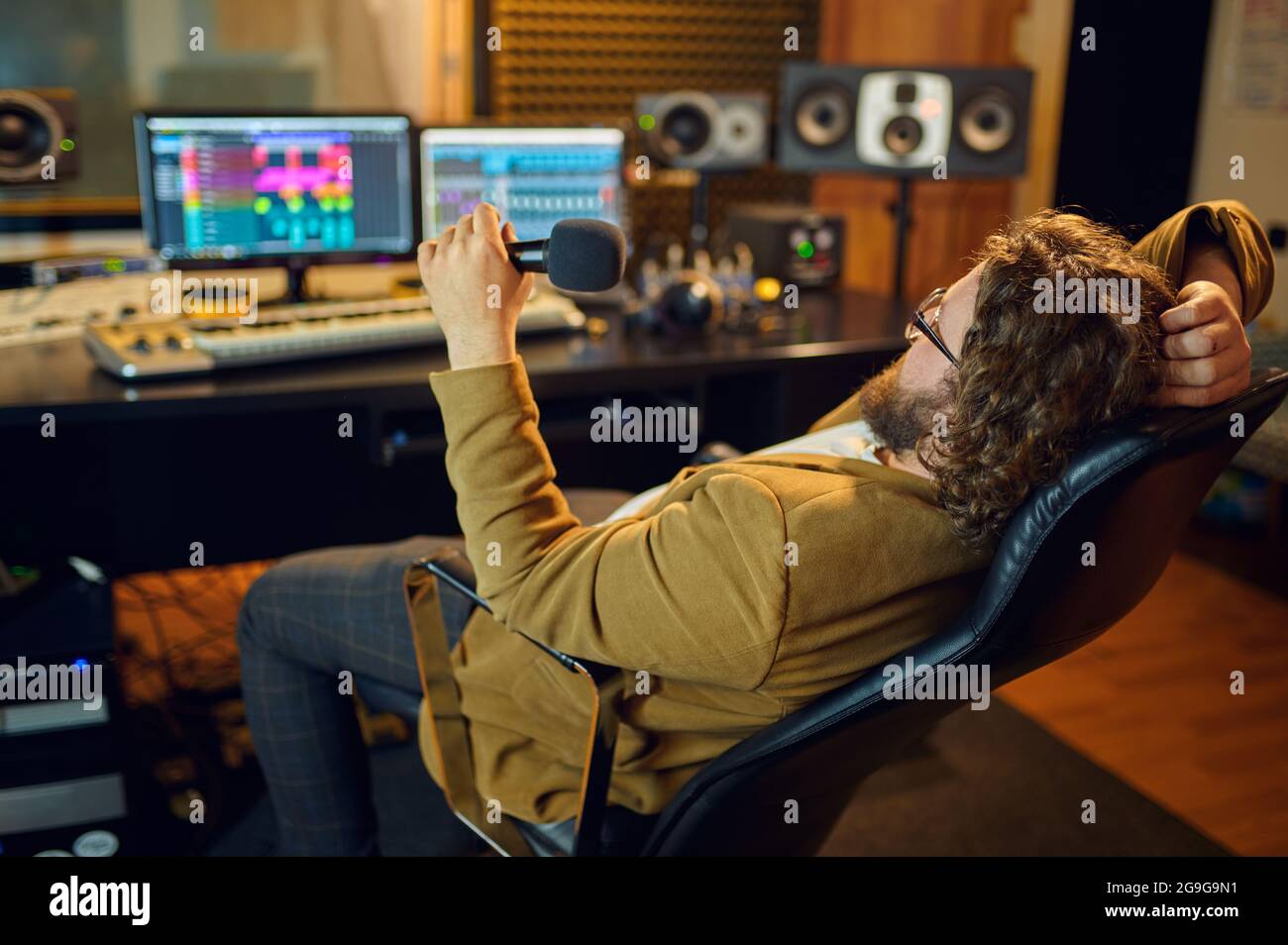 Male sound engineer at mixing consol, back view Stock Photo - Alamy