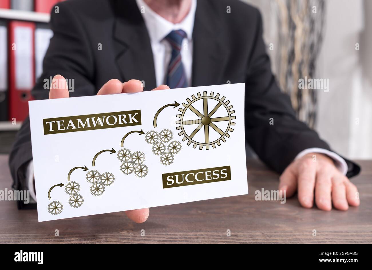 Businessman showing an index card with teamwork success concept Stock ...