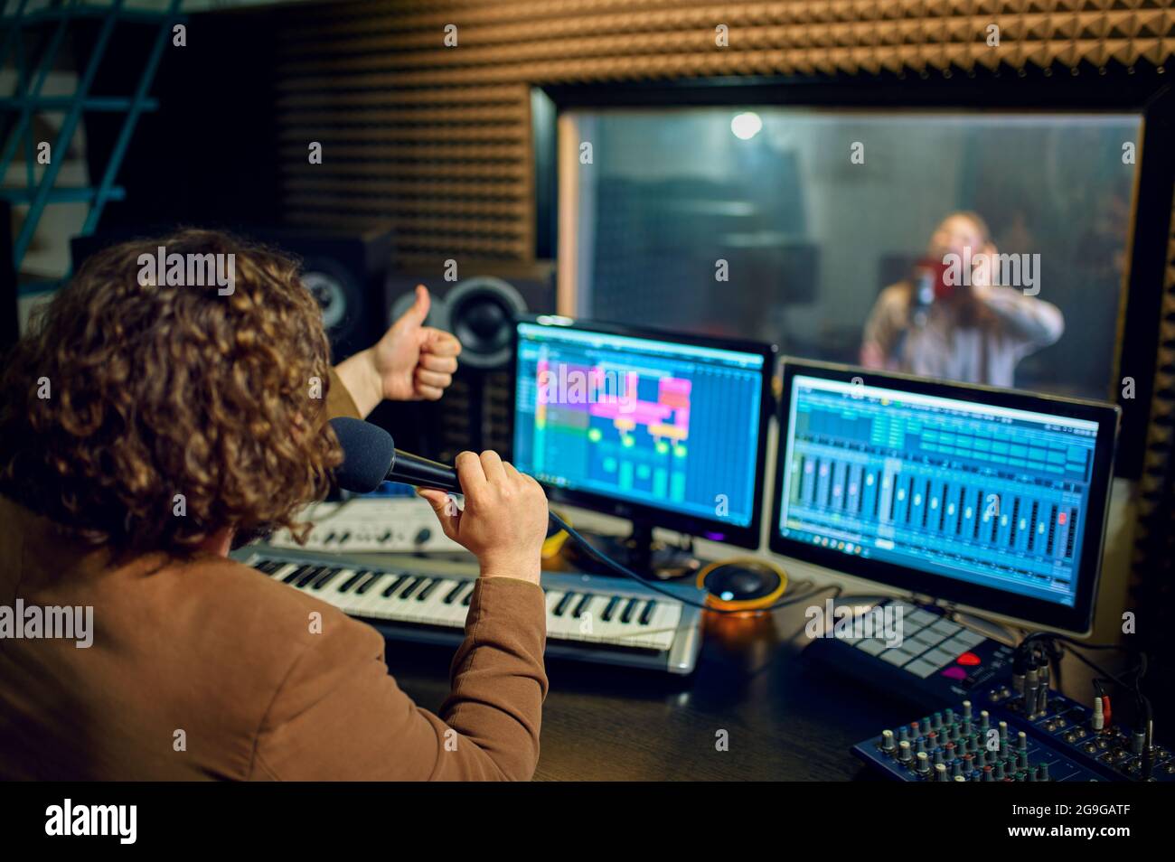 Musician and female performer, recording studio Stock Photo - Alamy