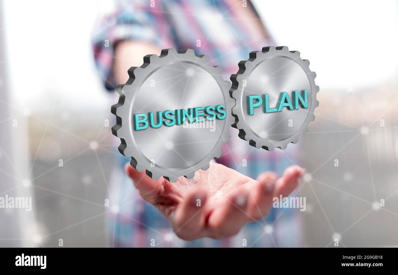 Business plan concept above the hand of a woman in background Stock ...