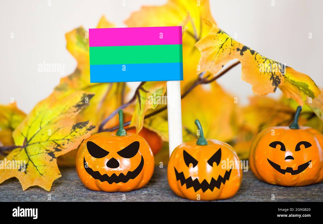 Colorful Halloween background with smiley pumpkins and toy flag of ...