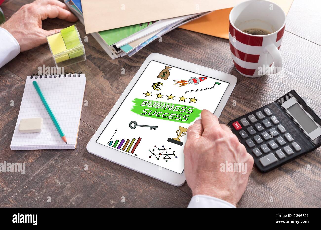 Man using a tablet showing a business success concept Stock Photo - Alamy